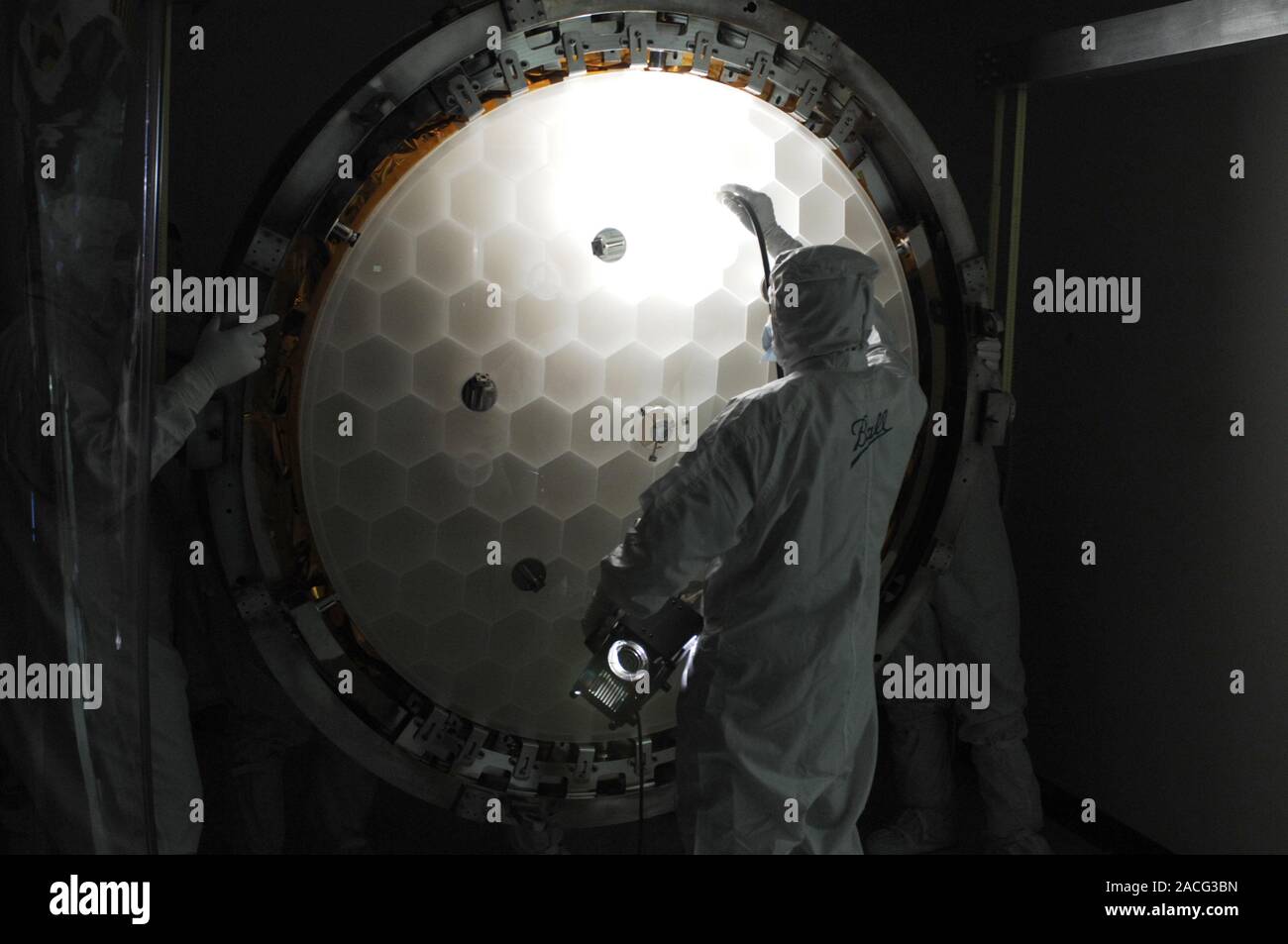 Kepler space telescope mirror. Technician examining the honeycomb ...