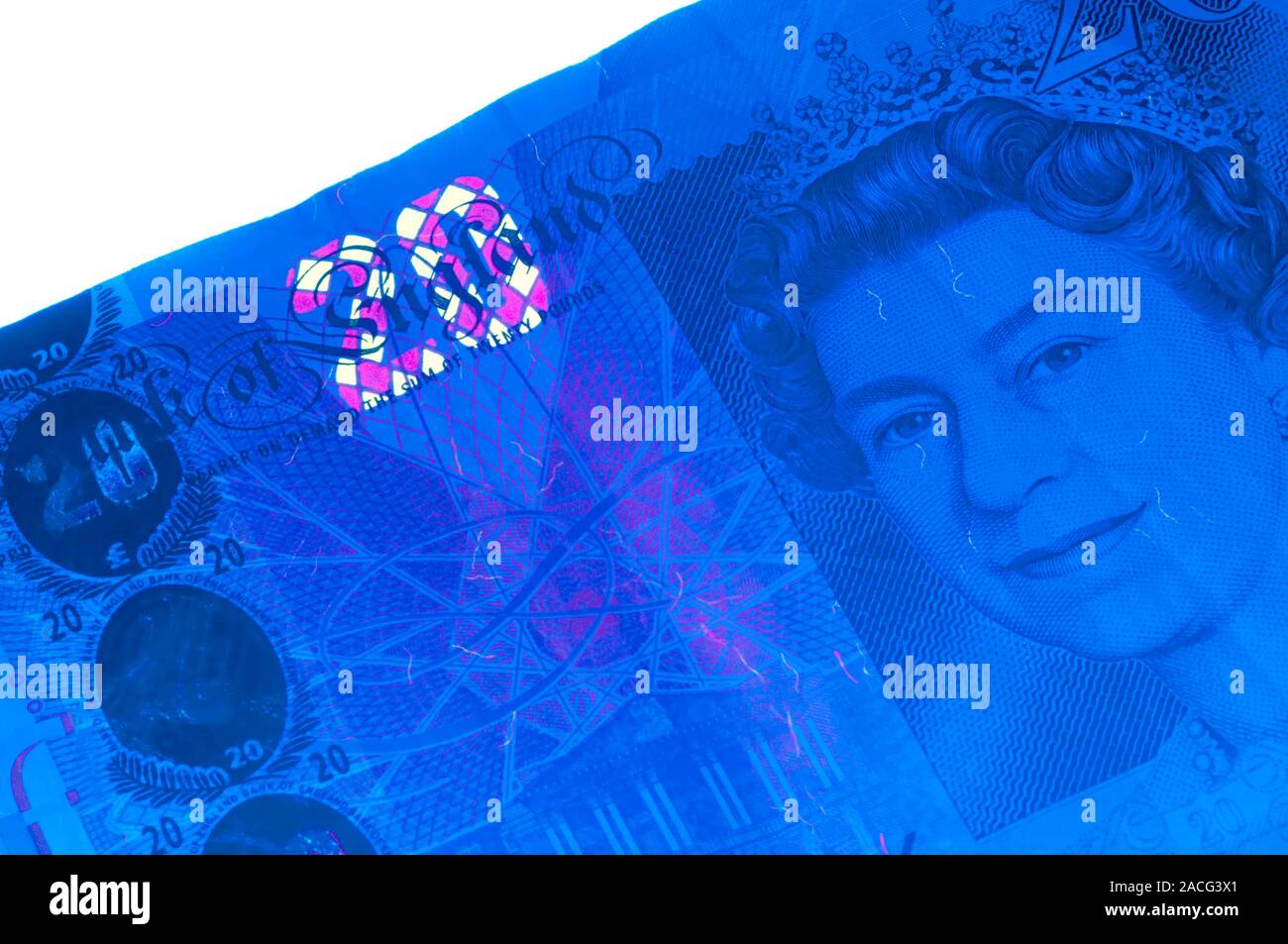 Twenty pound banknote in UV light, close up. The design on this ...
