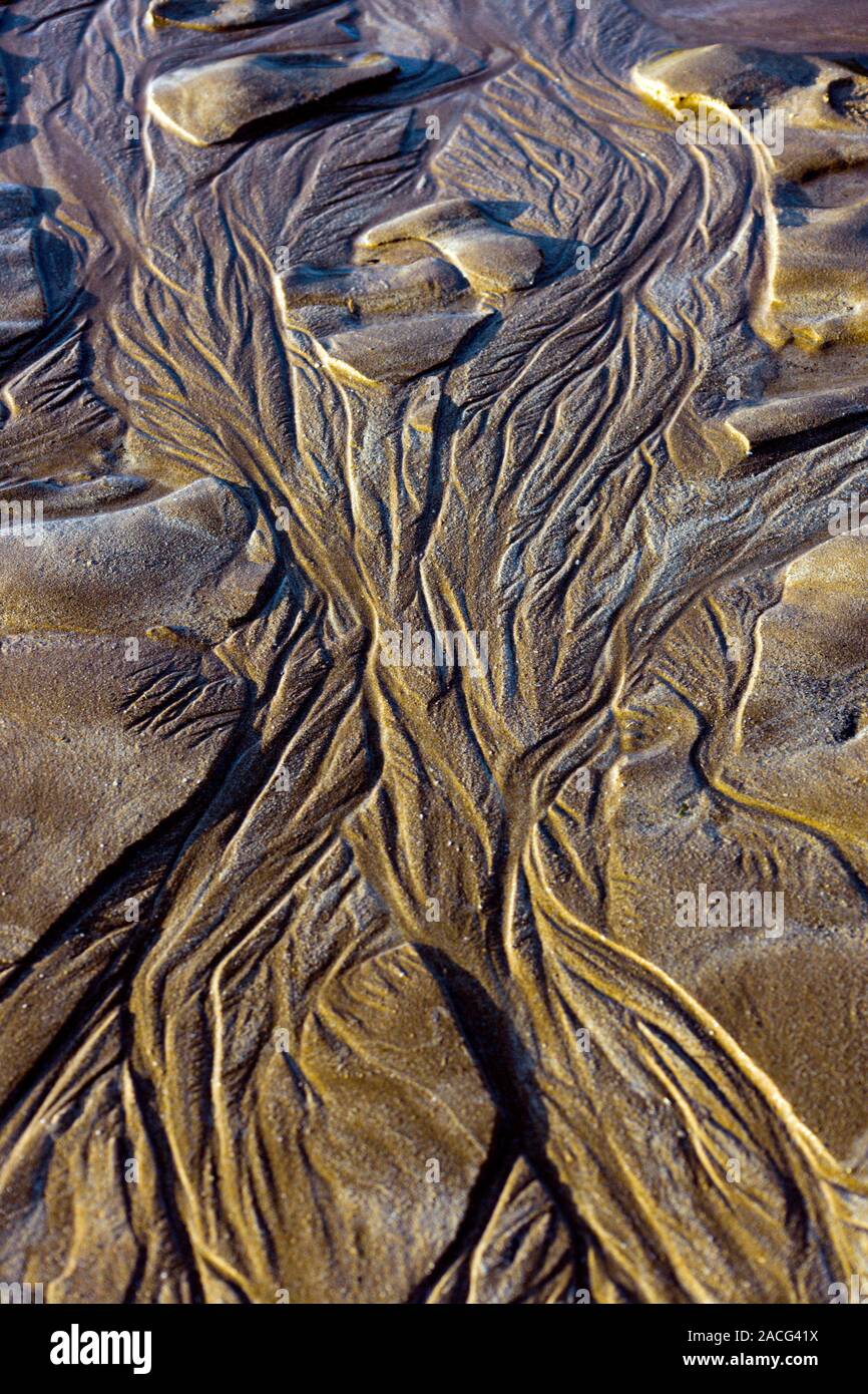 Sand patterns at low tide. Patterns in the sand caused by the flow and ...