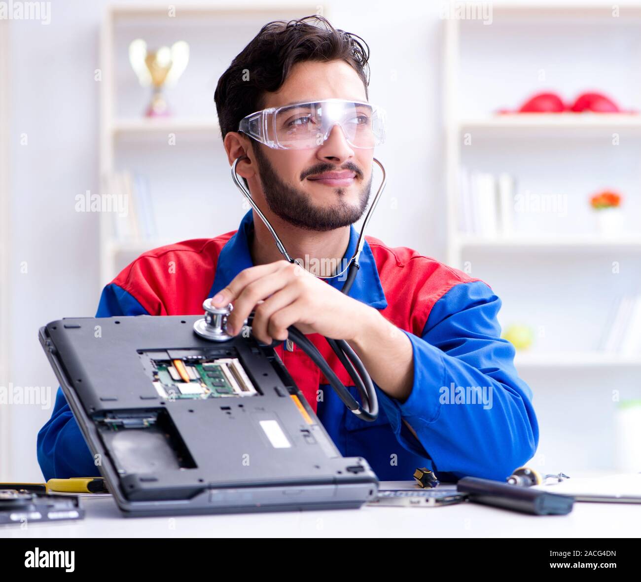 Repairman working in technical support fixing computer laptop ...