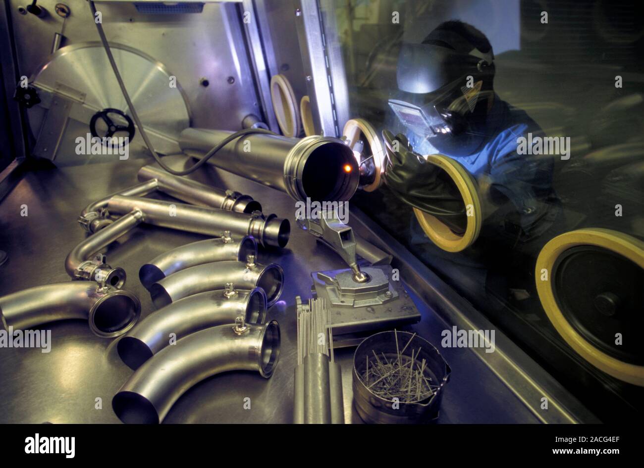 Passenger aircraft construction. Worker using an isolation cabinet to ...