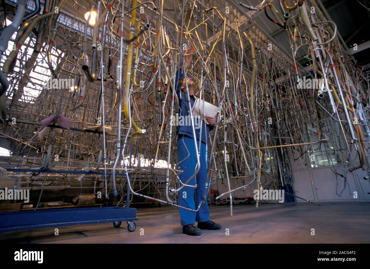 Passenger aircraft construction. Worker amongst prototype sections of ...