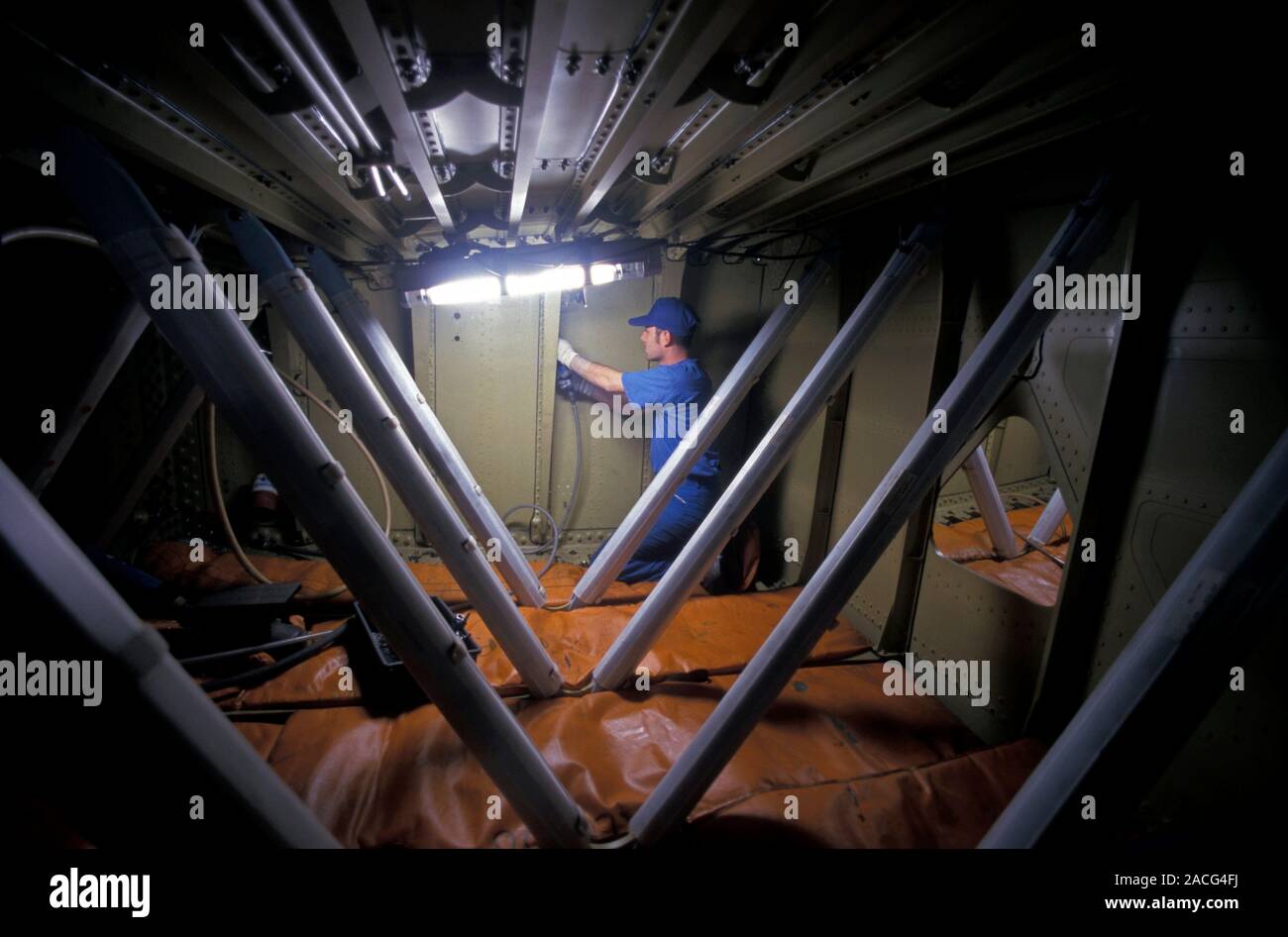 Passenger aircraft construction. Technician in the central fuel tank of ...