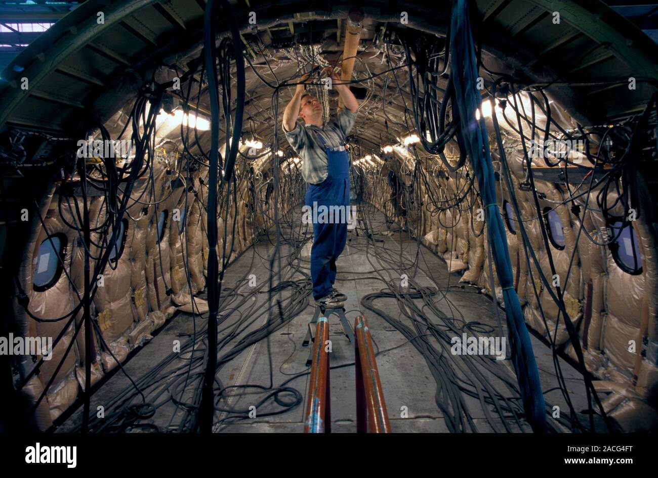 Passenger aircraft construction. Technician checking the electrical ...