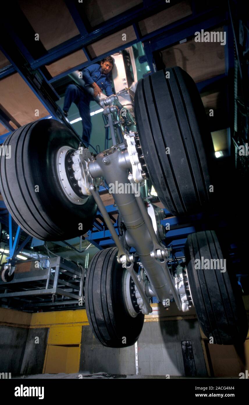 Passenger aircraft construction. Technician adjusting the landing gear ...