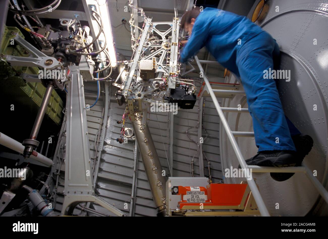 Passenger aircraft construction. Technician working on the emergency ...