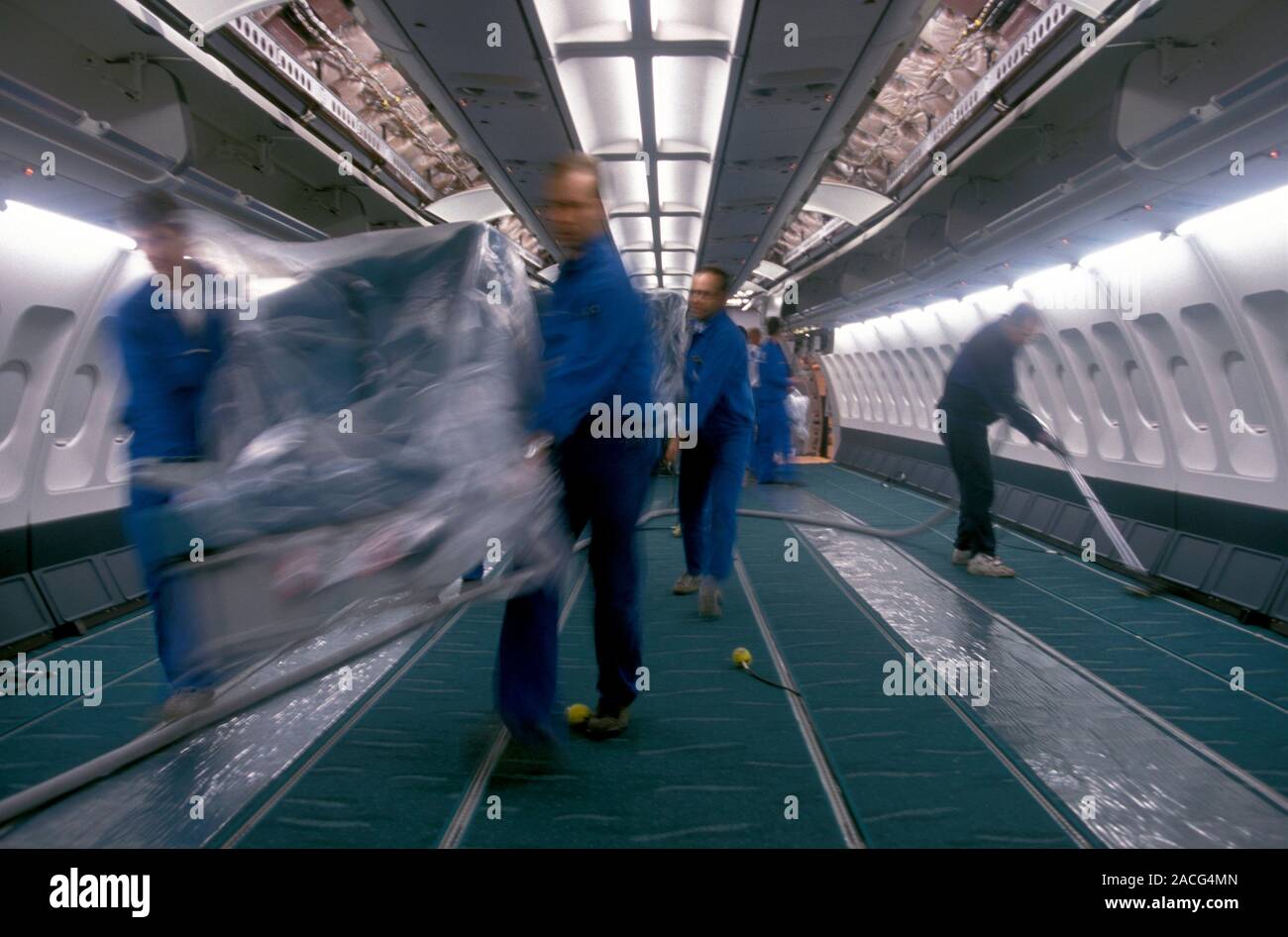 Passenger aircraft construction. Workers installing the final fittings ...