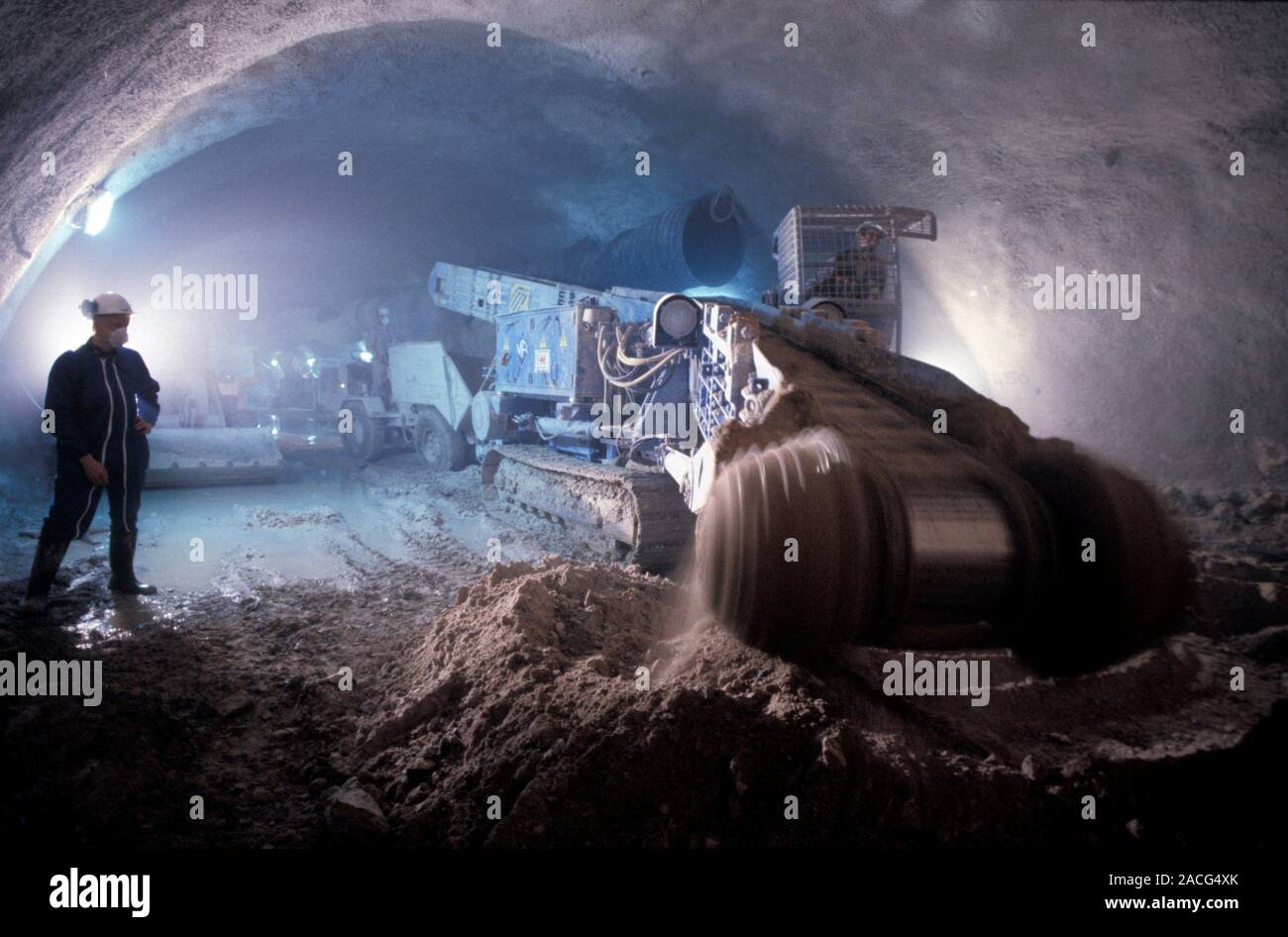 Metro train tunnel construction. Worker supervising the use of a ...