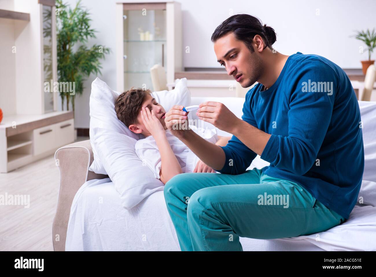 The young father caring for sick son Stock Photo - Alamy