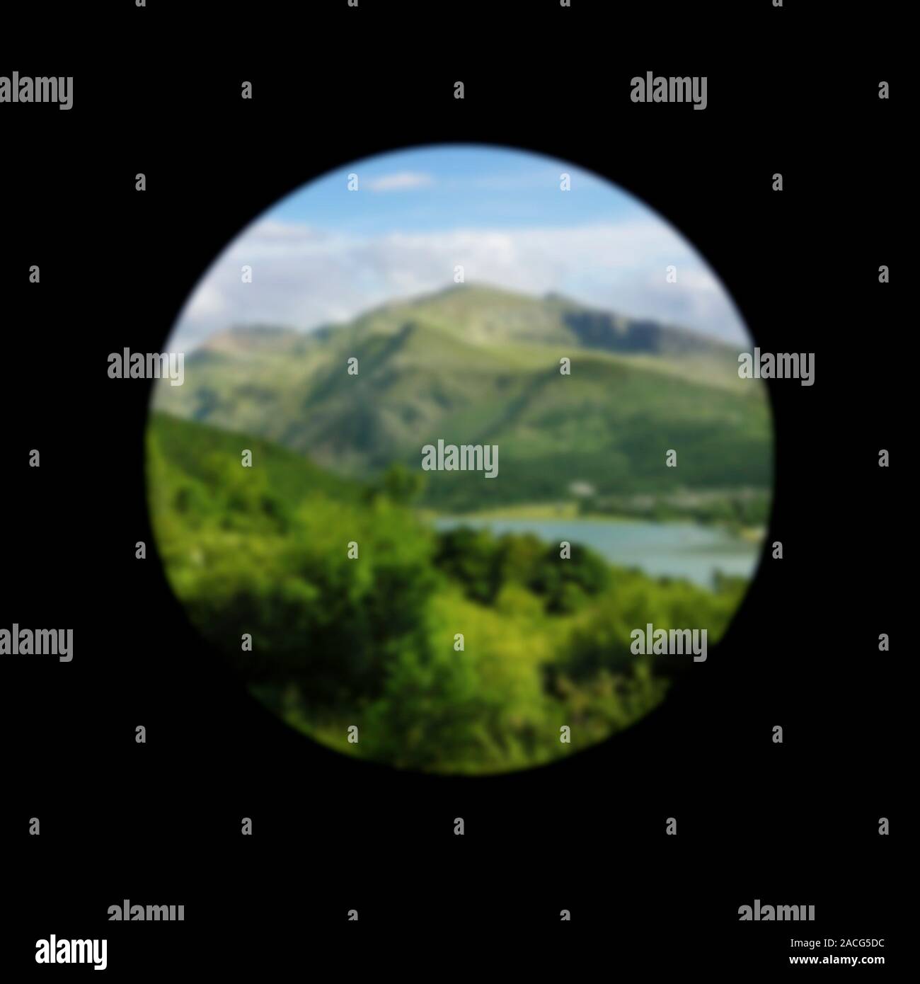 Blurred vision. Patient's-eye view of mountainous countryside, in a ...