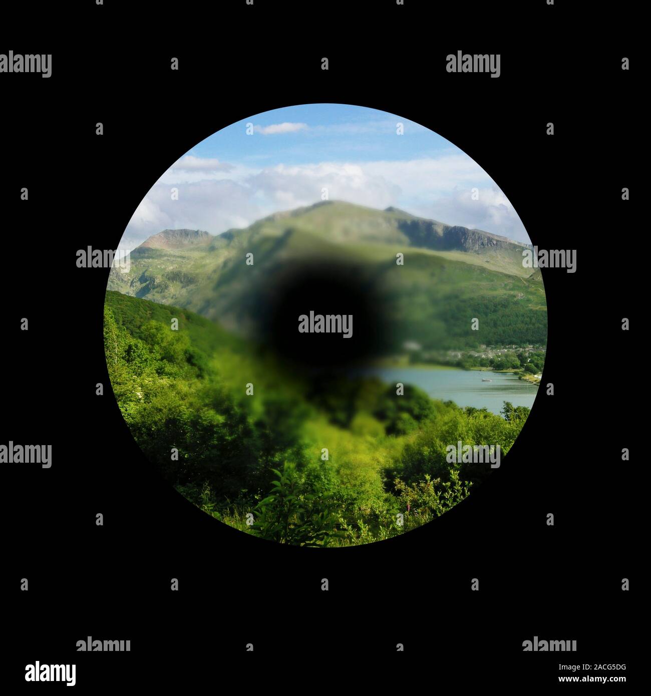 Macular degeneration. Patient's-eye view of mountainous countryside, in ...