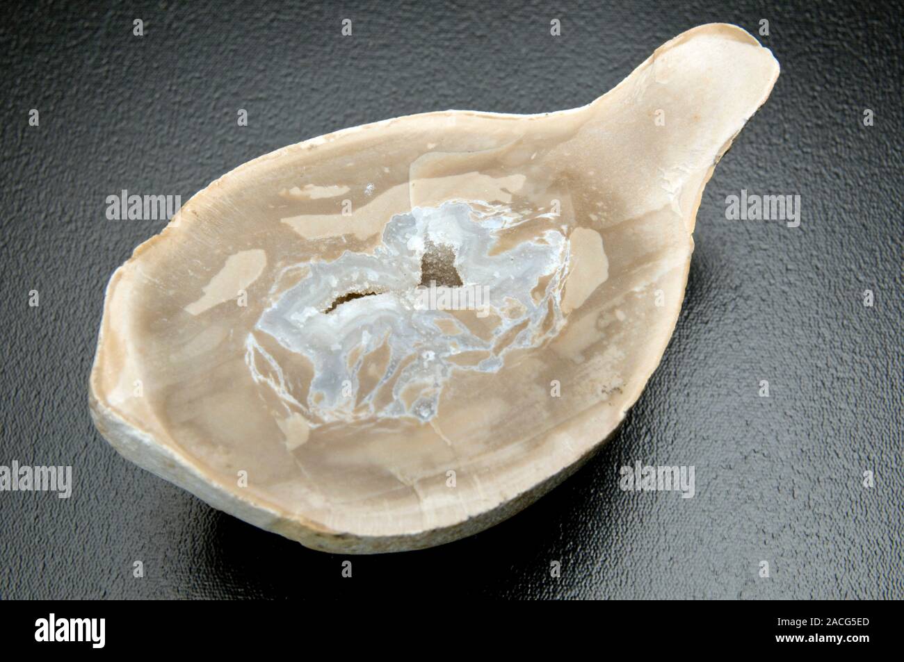 Crystal geode. Lump of rock cut in half showing crystals formed inside ...