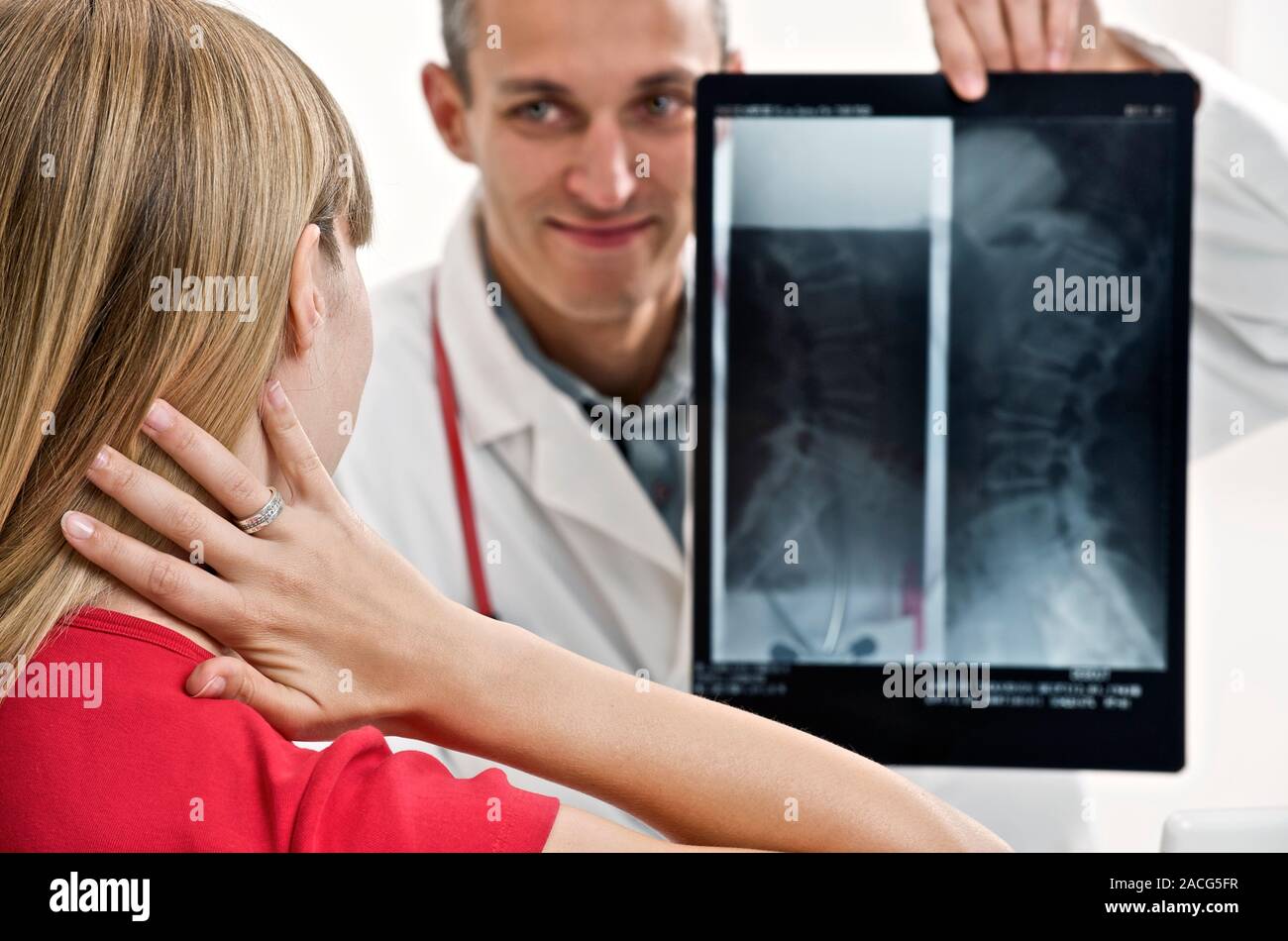 Neck X-ray. Doctor showing a patient X-rays of their neck Stock Photo ...