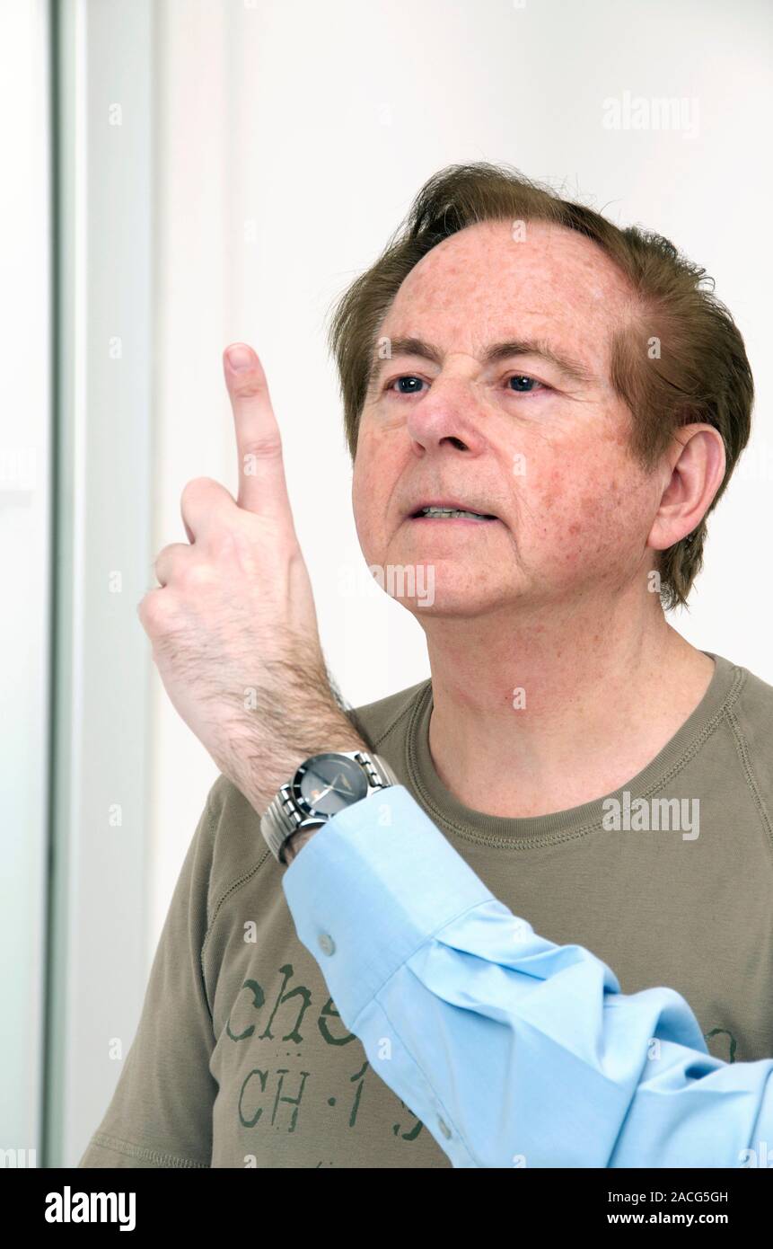 Neurological examination. Doctor performing the 'follow my finger' test ...