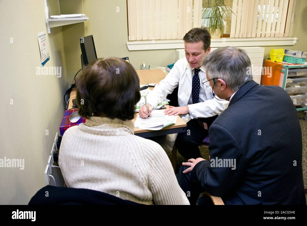 Prostate cancer treatment consultation. Doctor with a male patient and ...