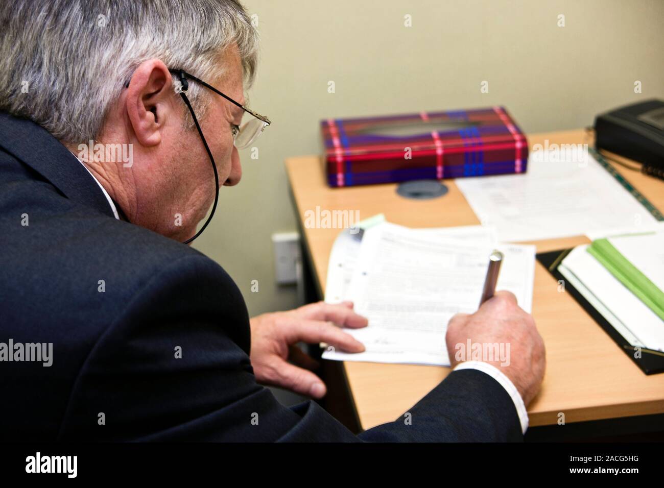 Prostate cancer treatment consent forms. Male patient filling in ...