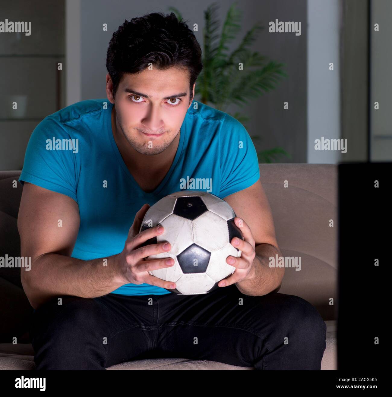 The young man watching football late at night Stock Photo - Alamy