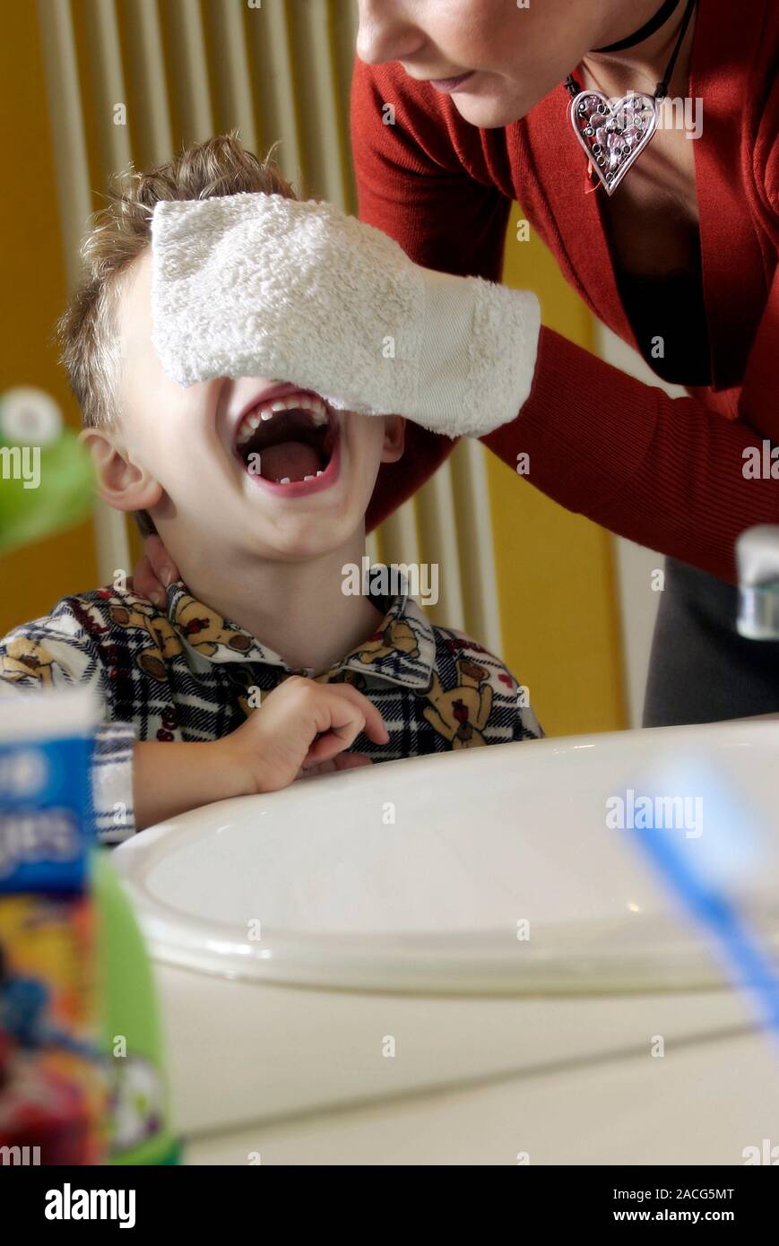 Mother washing her son's face Stock Photo - Alamy