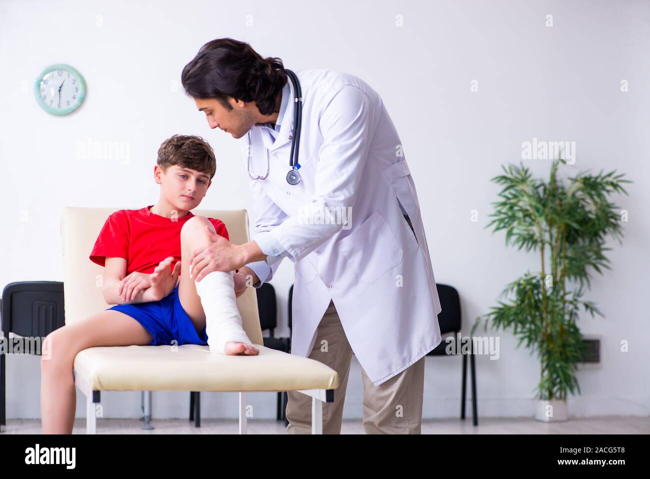 The leg injured boy visiting young doctor traumatologist Stock Photo ...