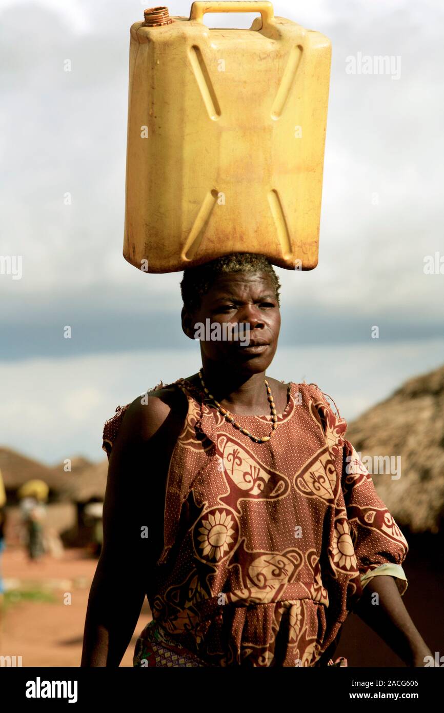 Woman carrying water. Photographed in Uganda Stock Photo - Alamy
