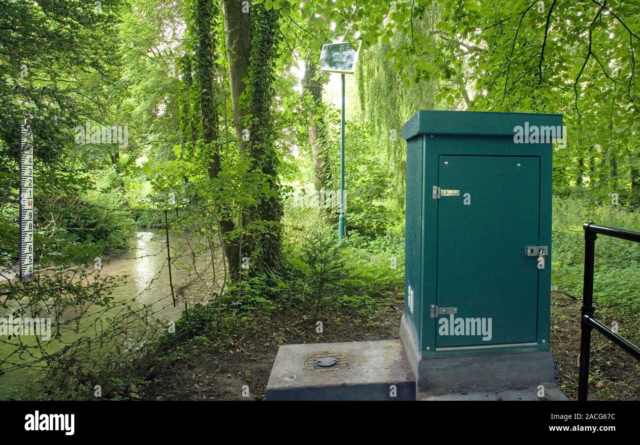 Flood monitor. River water level gauge located by a tributary of the ...