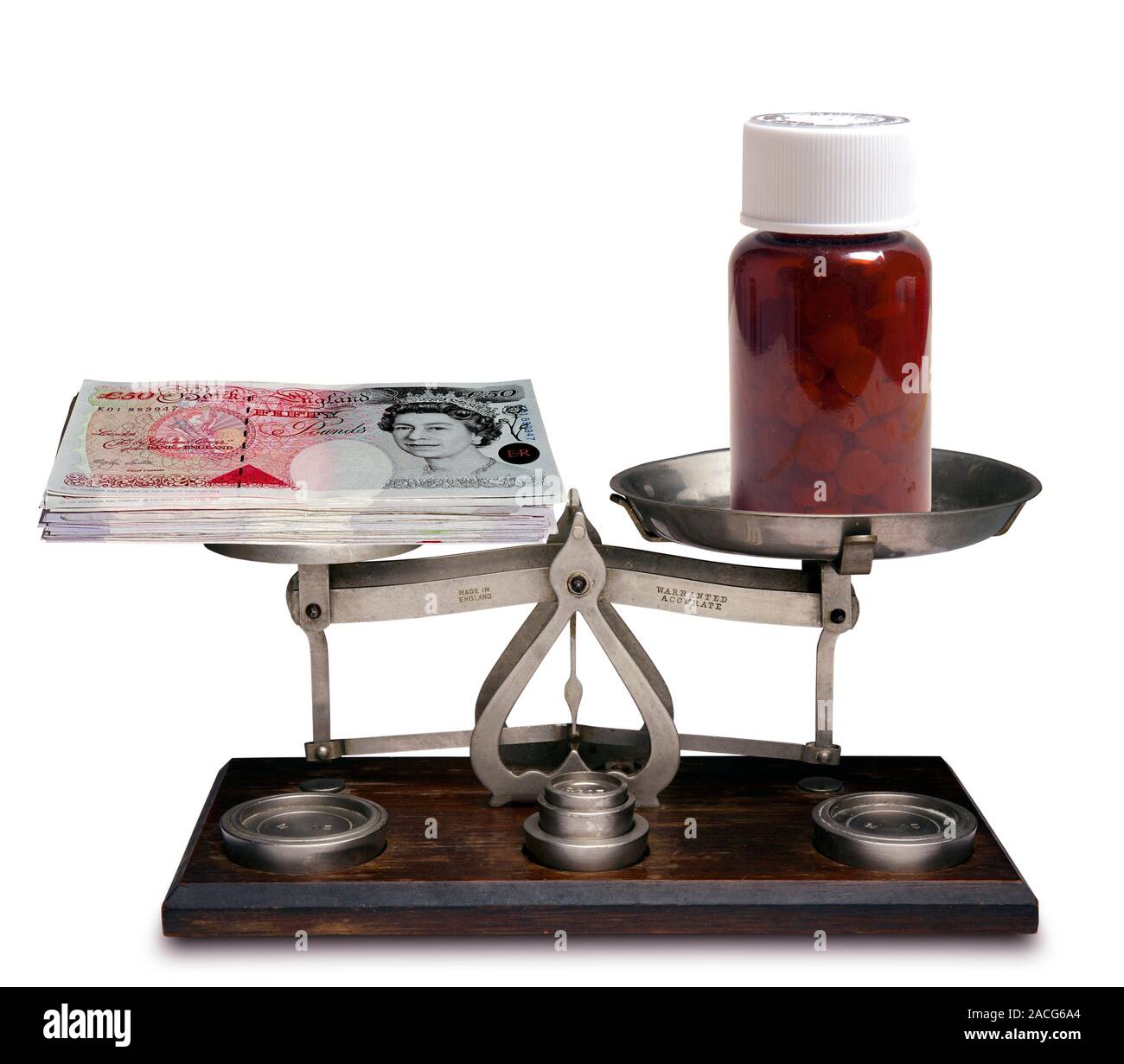 Cost of medicine, conceptual image. Pill bottle balanced on a set of ...