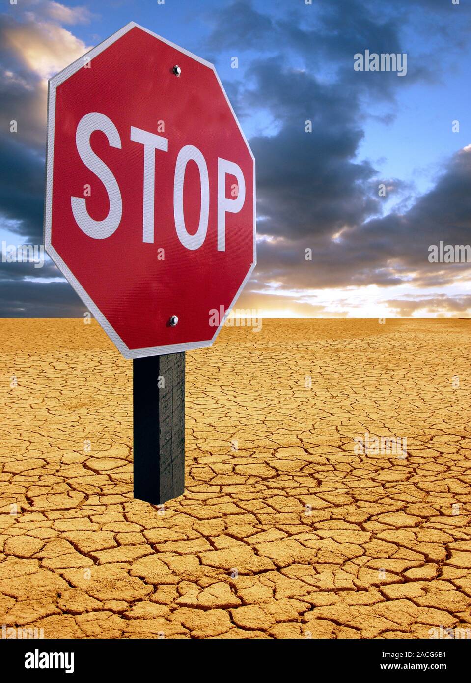 Global warming warning, conceptual image. Stop sign buried in dried mud ...