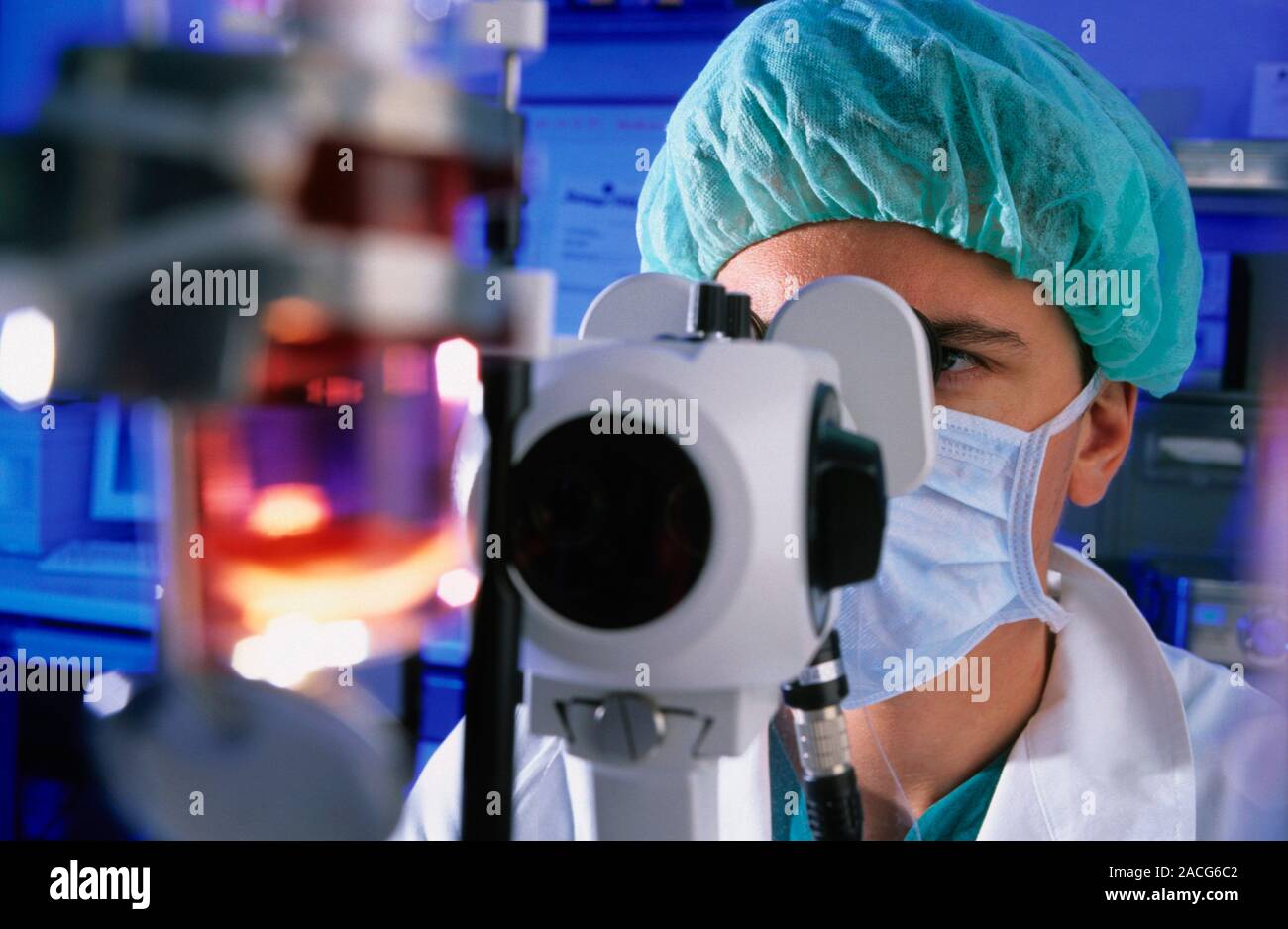Human eye cornea harvesting. Laboratory technician examining a human ...