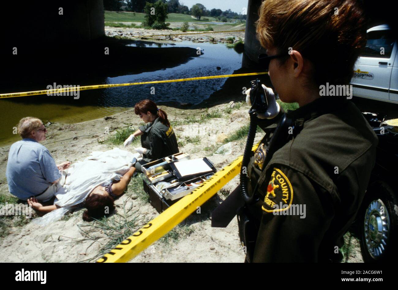 Murder investigation. Forensics officer and police collecting evidence ...
