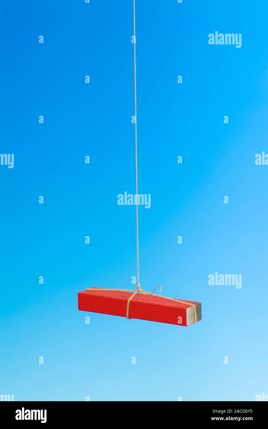 Free-hanging magnet. Bar magnet suspended on a string, aligning itself ...