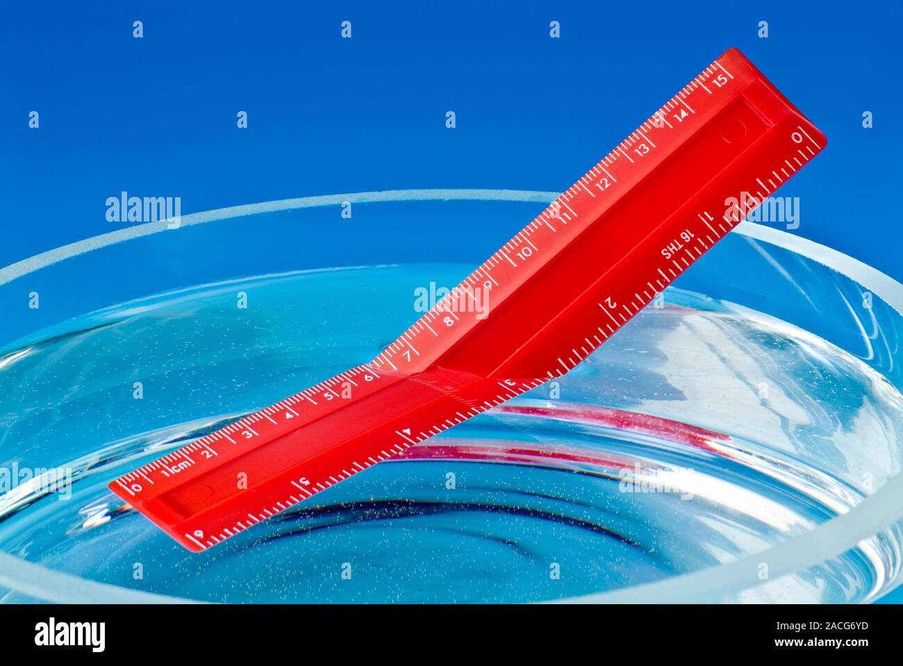 Refraction in water experiment. The ruler appears to bend because light ...