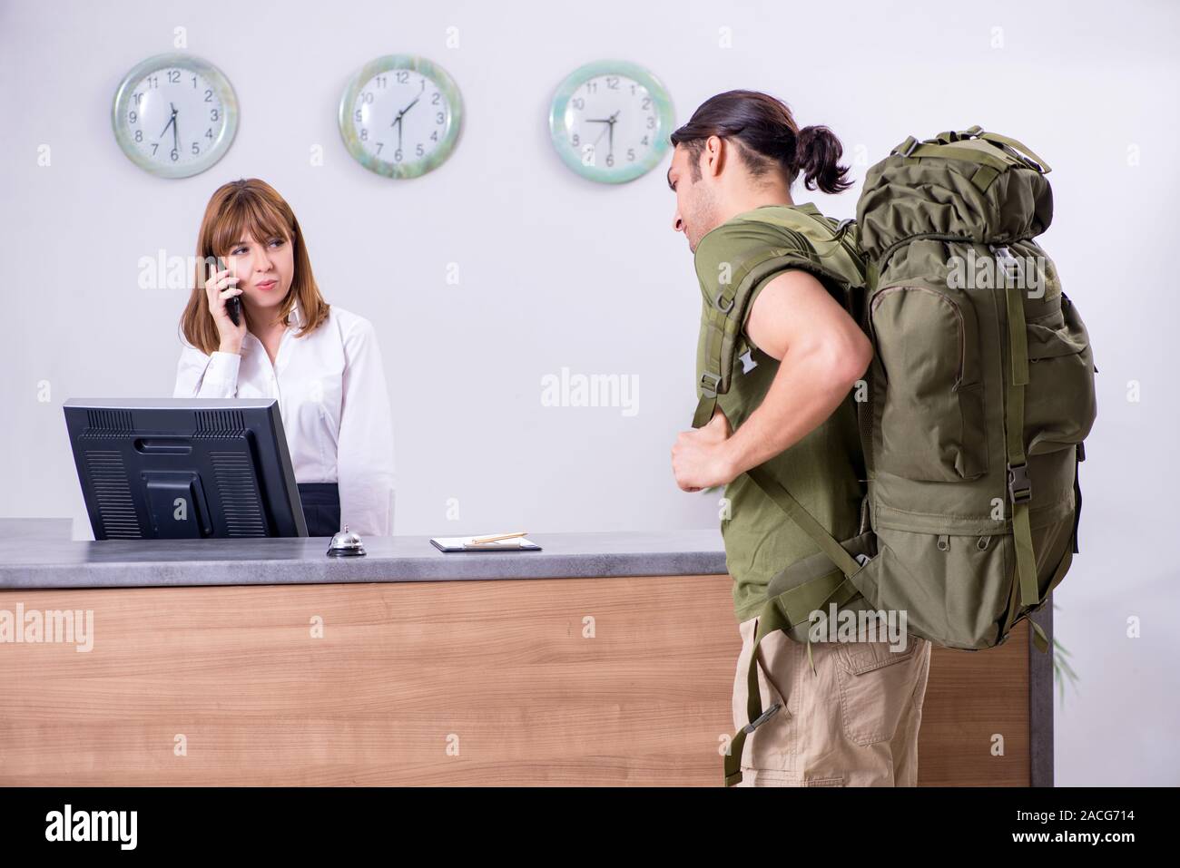 The young man at the hotel reception Stock Photo - Alamy