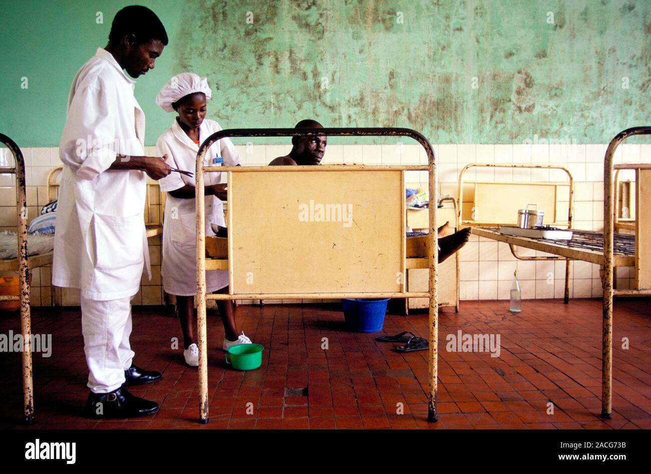 Congo hospital. Doctor (left) and nurse (centre) checking on a patient ...