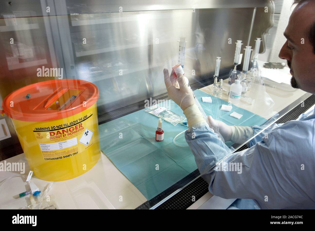 Cytotoxic drug preparation. Pharmacist using aseptic (sterile ... Cytotoxic drug preparation. Pharmacist using aseptic (sterile ...