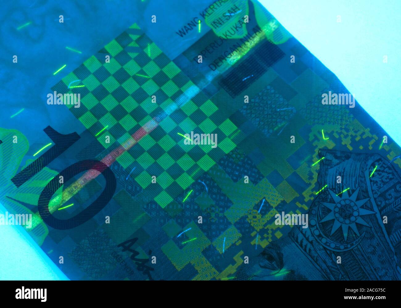 Malaysian banknote in UV light. Close up of a ten ringgit Malaysian ...