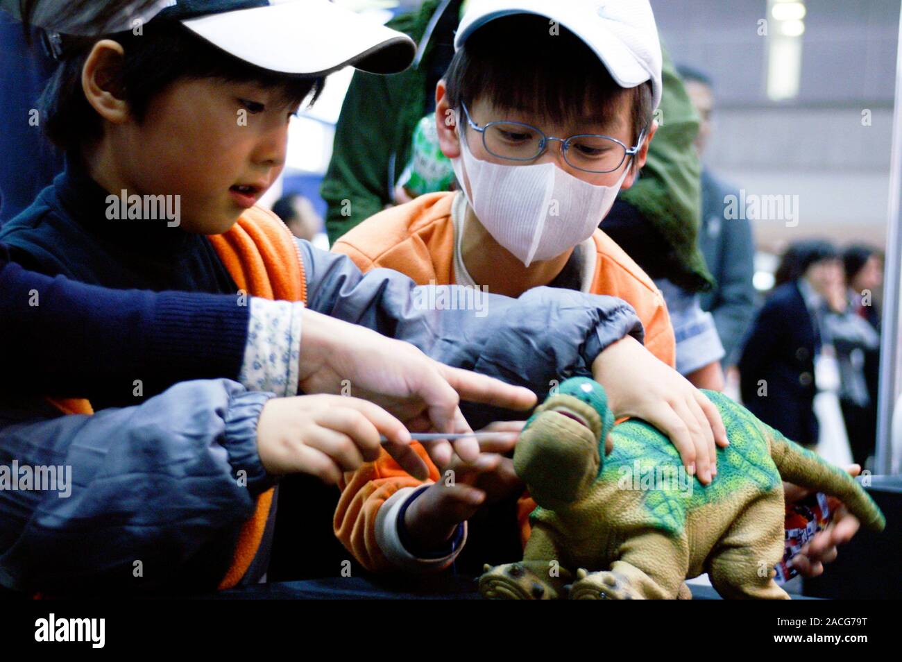 Toy robot. Children playing with a robotic toy dinosaur. Photographed ...