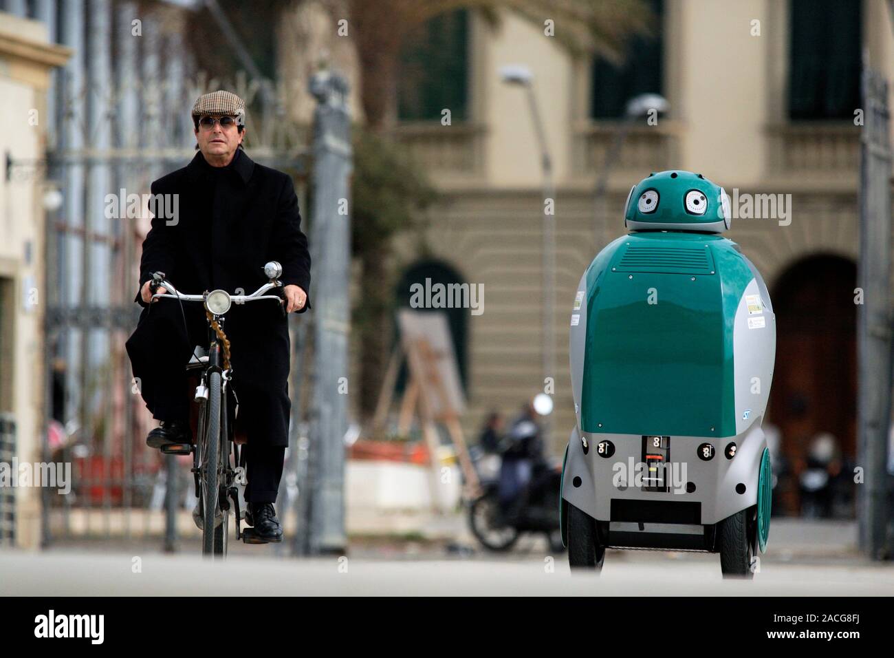 DustBot robot and cyclist. DustBot is a wheeled robot designed to ...