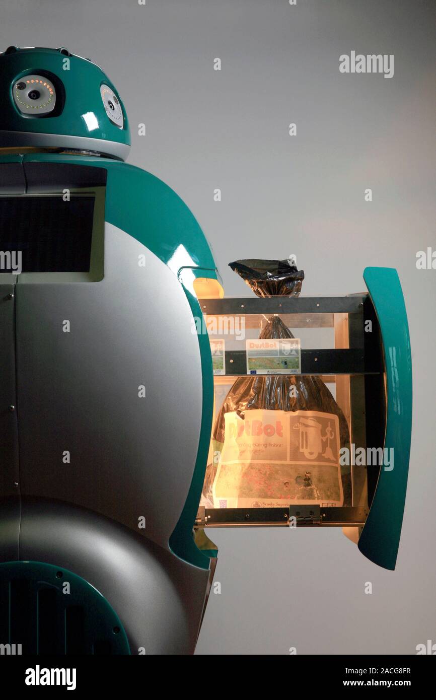 DustBot robot collecting rubbish. DustBot is a wheeled robot designed ...