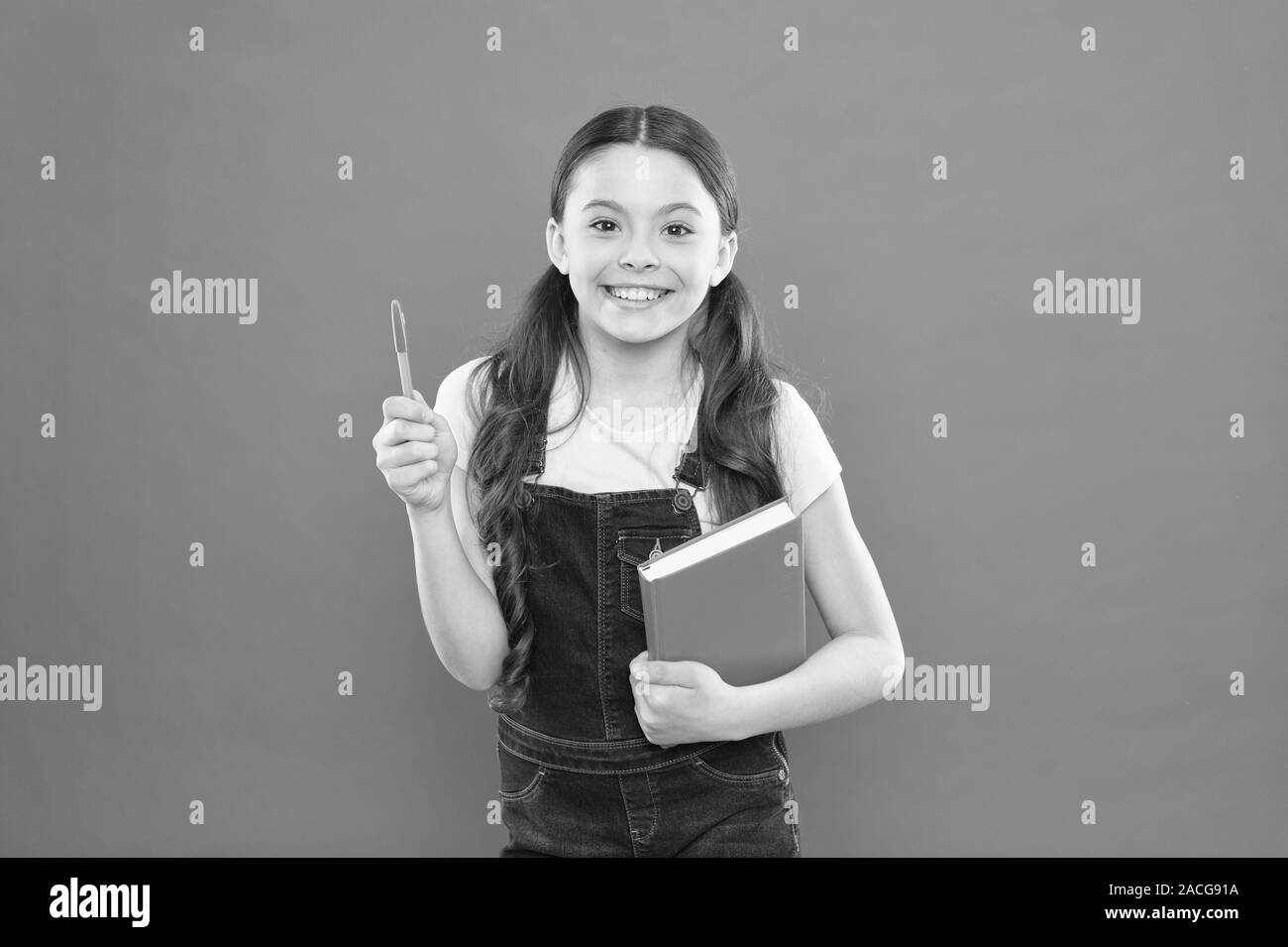 Concentrated on studying. happy little girl with notebook. literature ...