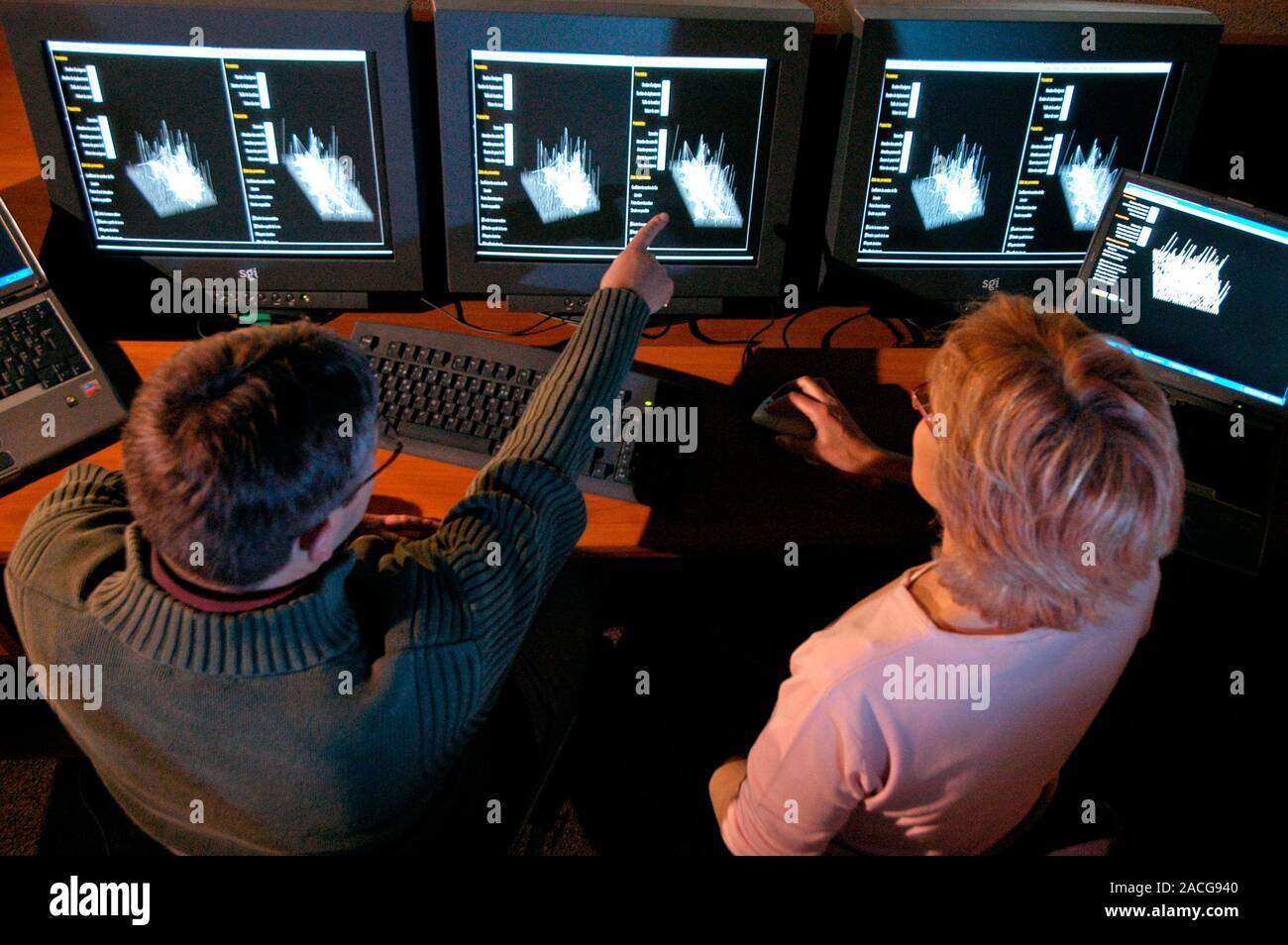 Spider research. Two researchers examining computer displays of the ...