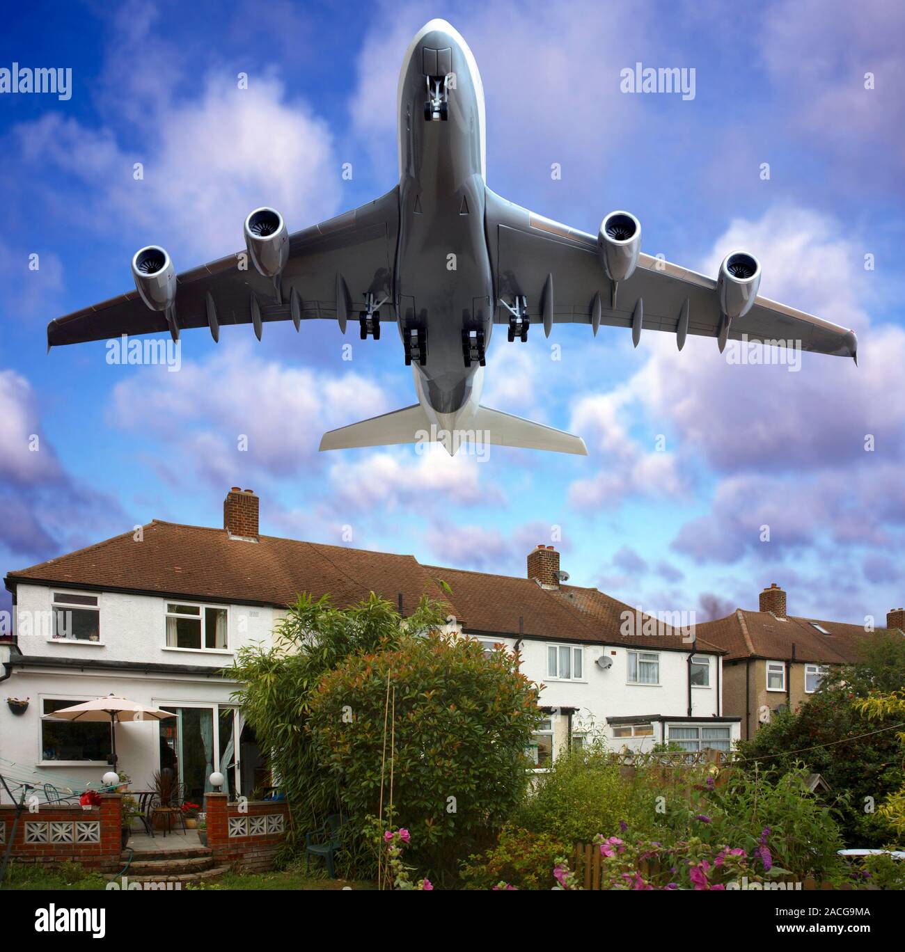 Low flying plane passing over houses, composite image Stock Photo - Alamy