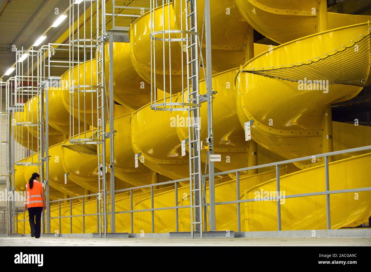 Parcel processing centre. Worker checking part of a post sorting ...