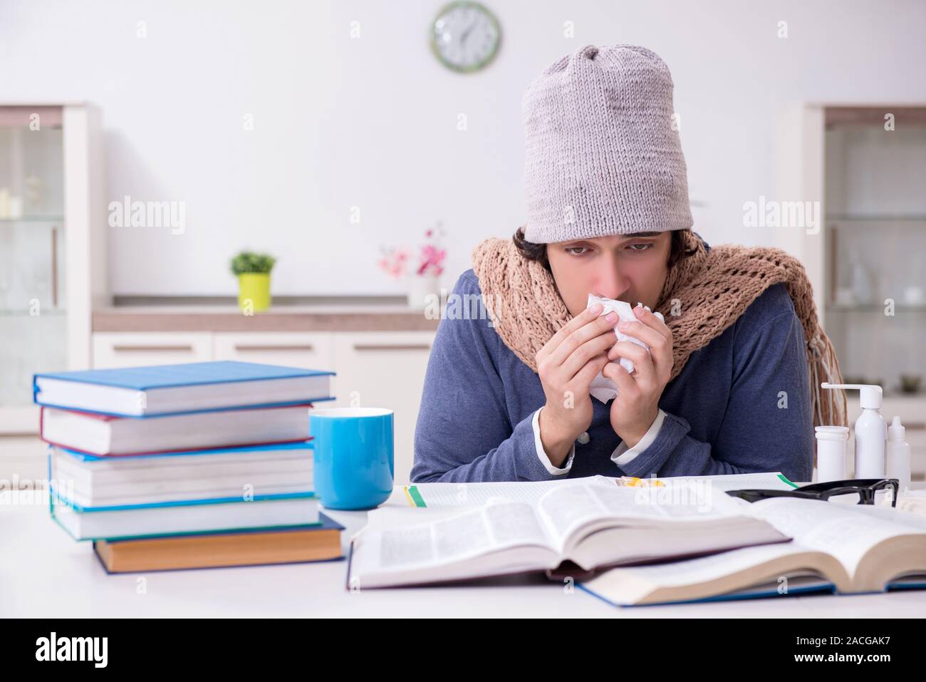 The sick male student suffering at home Stock Photo - Alamy