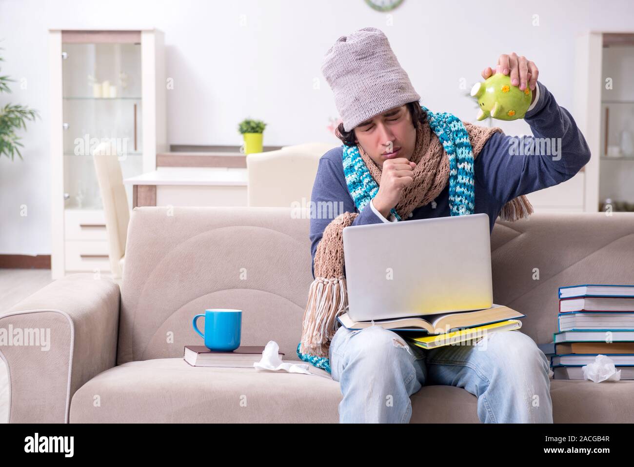 The sick male student suffering at home Stock Photo - Alamy
