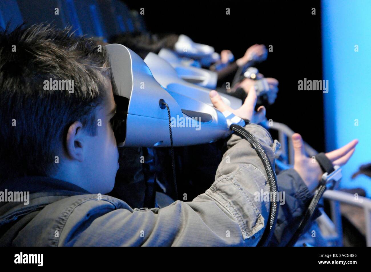 Interactive theme park display. Child using a binocular viewer to watch ...