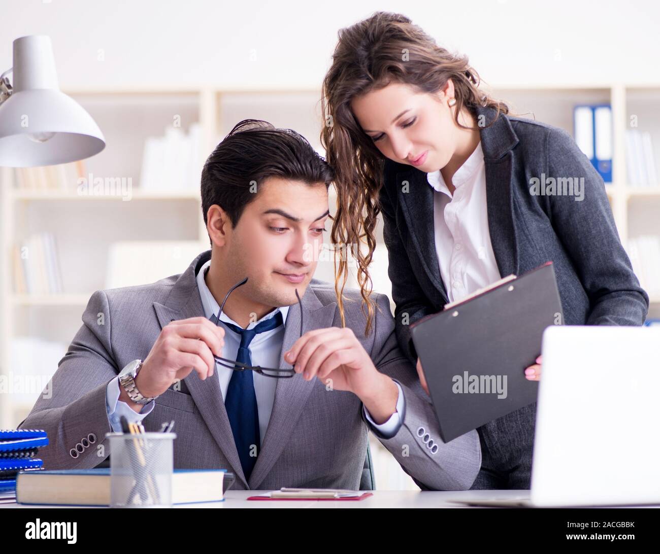 Unhappy boss having a chat with his secretary Stock Photo - Alamy