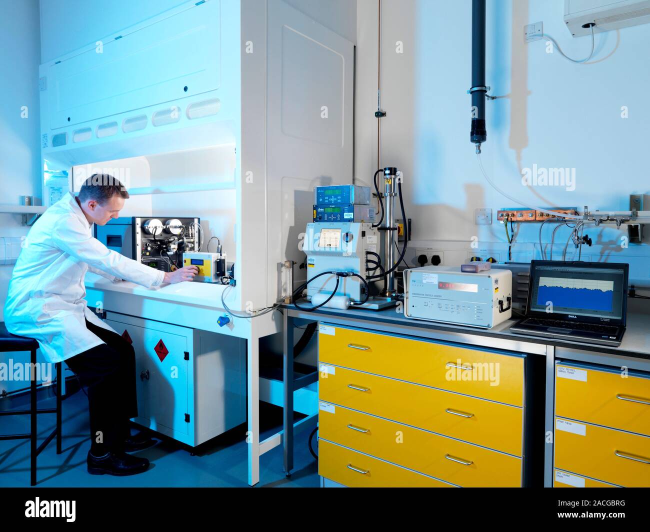 Airborne nanoparticle metrology. Scientist using specialist equipment ...