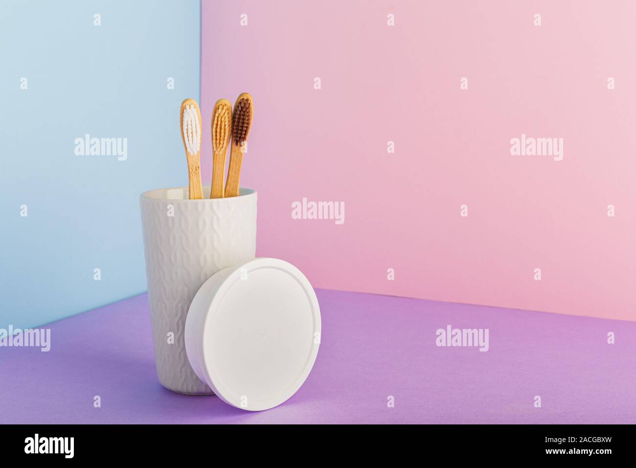 Bamboo toothbrushes and dentifrice tooth powder on color pink ...