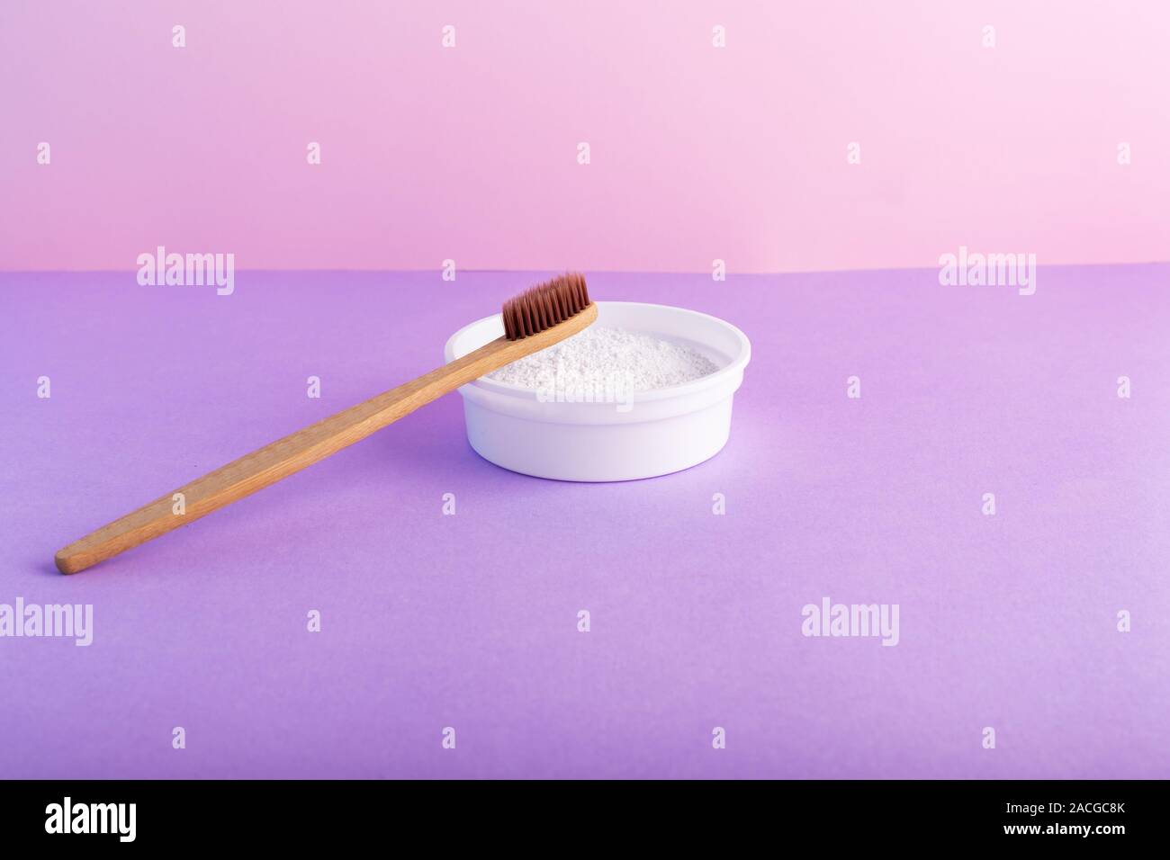 Bamboo toothbrushes, dentifrice tooth powder on color pink background ...