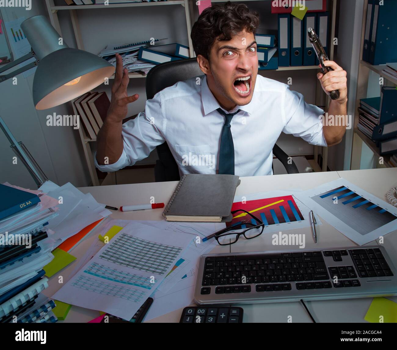 The man businessman working late hours in the office Stock Photo - Alamy